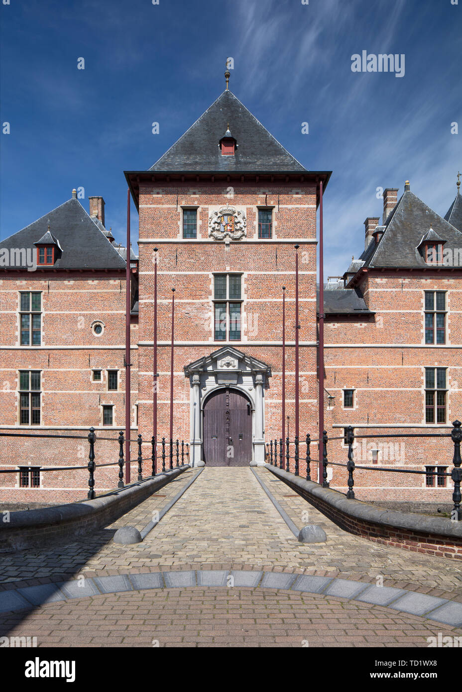 Cobblestone walkway to ornate gate of a medieval brick castle, Europe ...