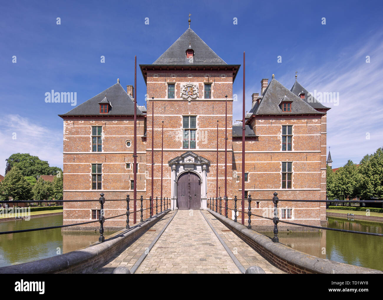 Cobblestone walkway to ornate gate of a medieval brick castle, Europe ...