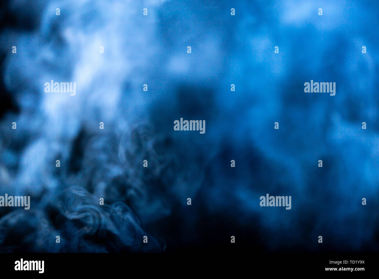 Blue smoke on a black background Stock Photo - Alamy