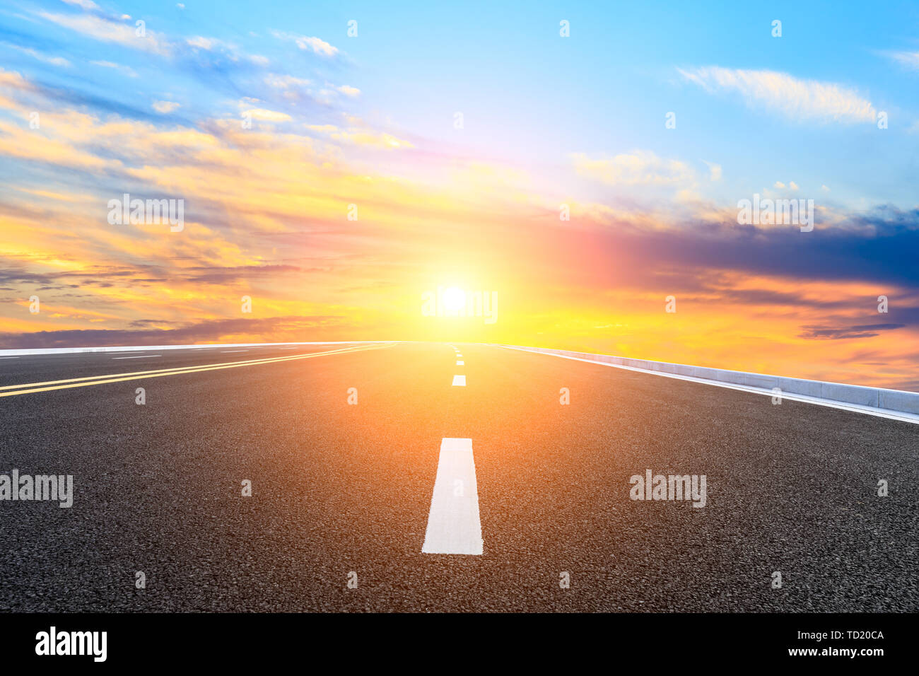 Straight asphalt road and sunset sky Stock Photo - Alamy