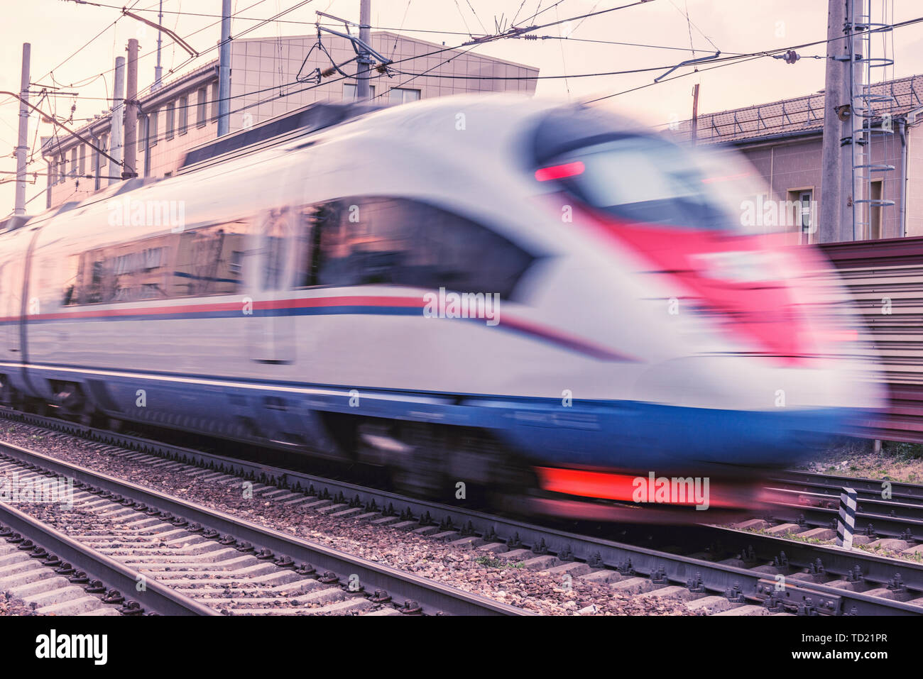 Passenger train moves fast at sunset time Stock Photo - Alamy