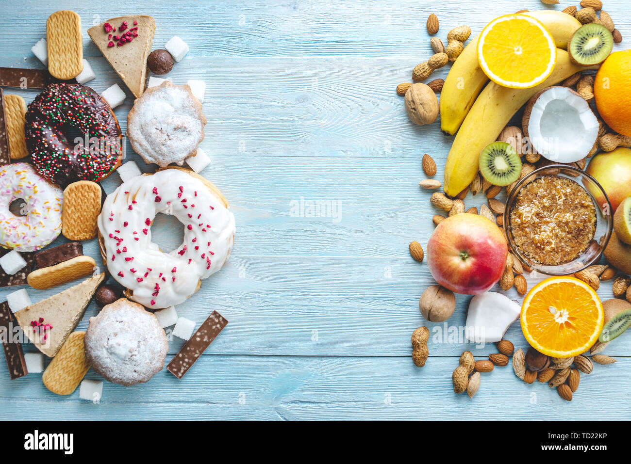 Unhealthy and healthy sweets on blue wooden background. Organic and ...