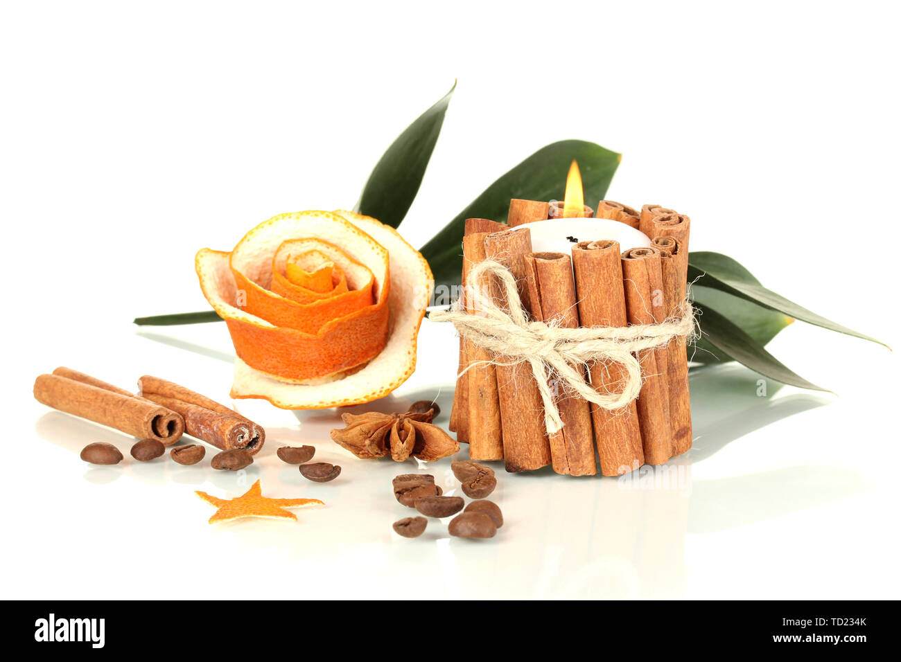 Decorative rose from dry orange peel and burning candle isolated on ...