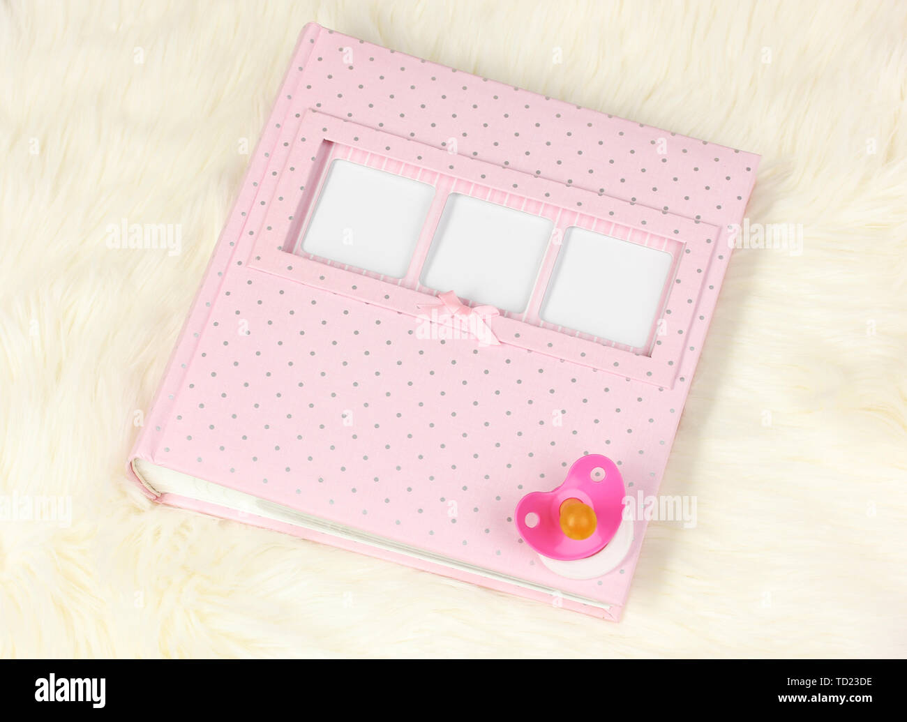 Baby photo album on white carpet Stock Photo - Alamy