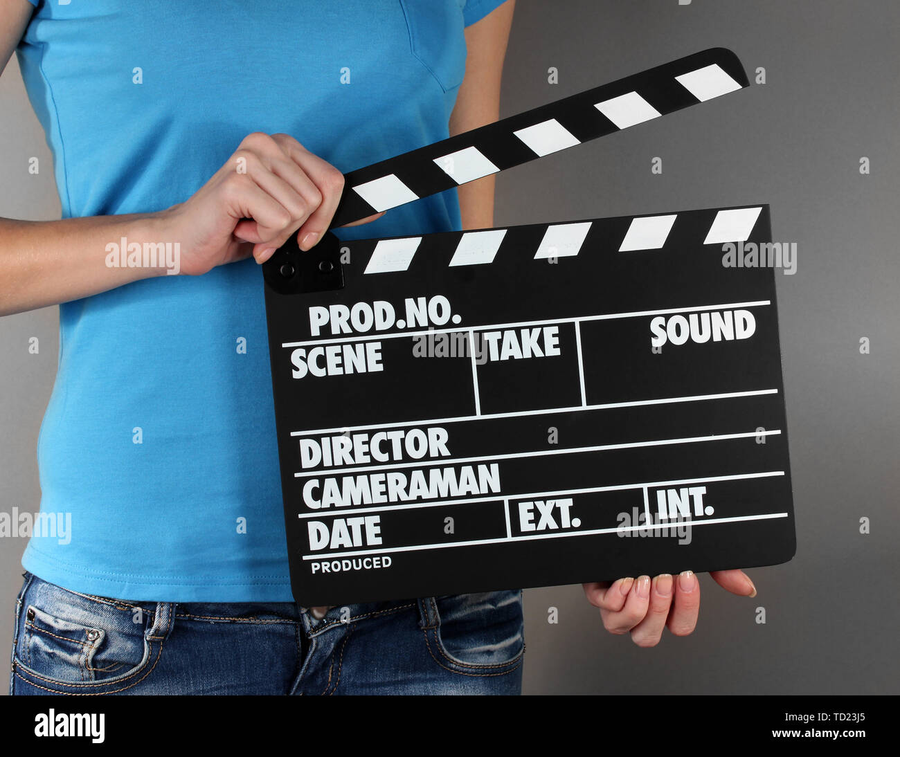 Movie production clapper board in hands on grey background Stock Photo ...