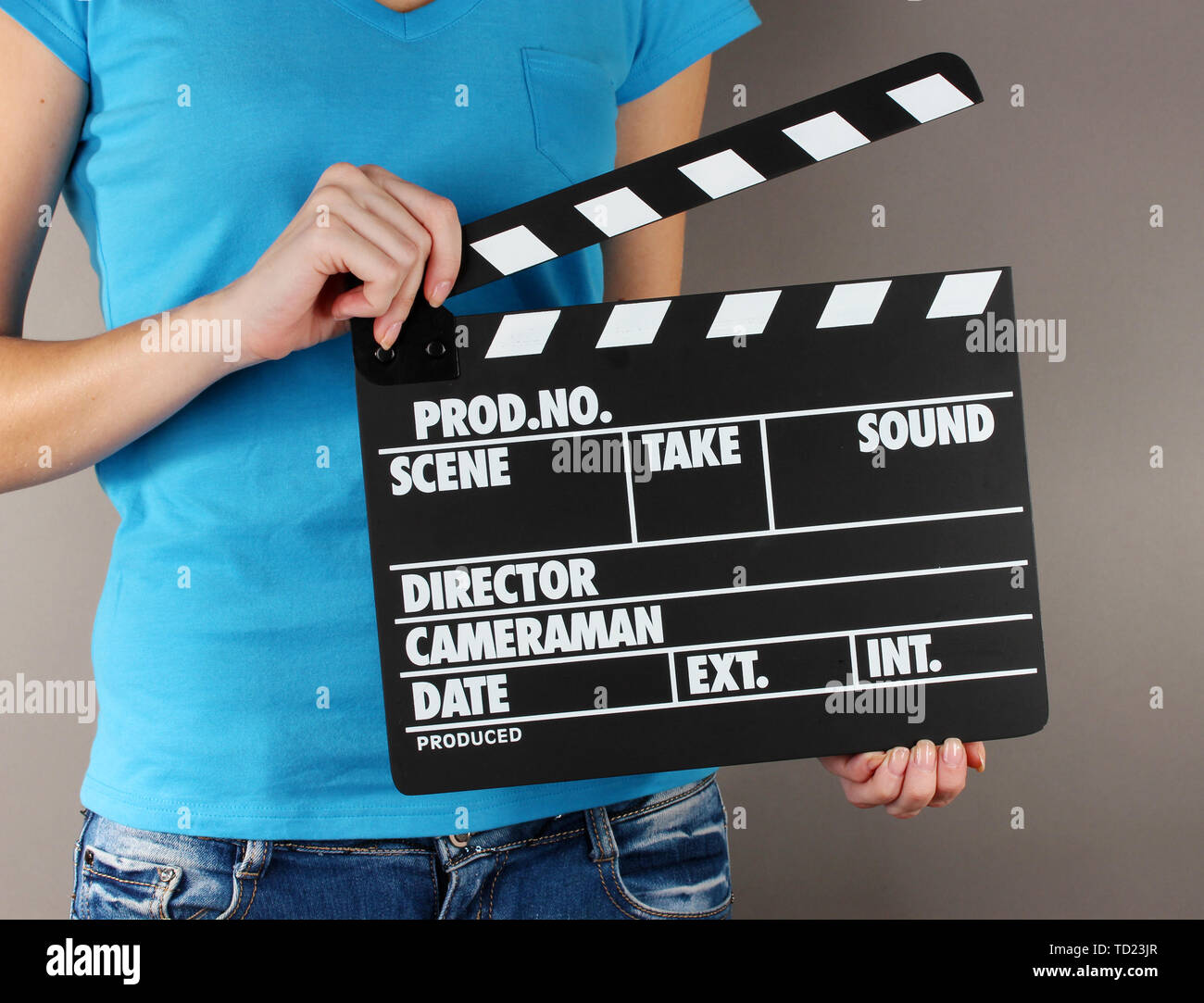 Movie production clapper board in hands on grey background Stock Photo ...