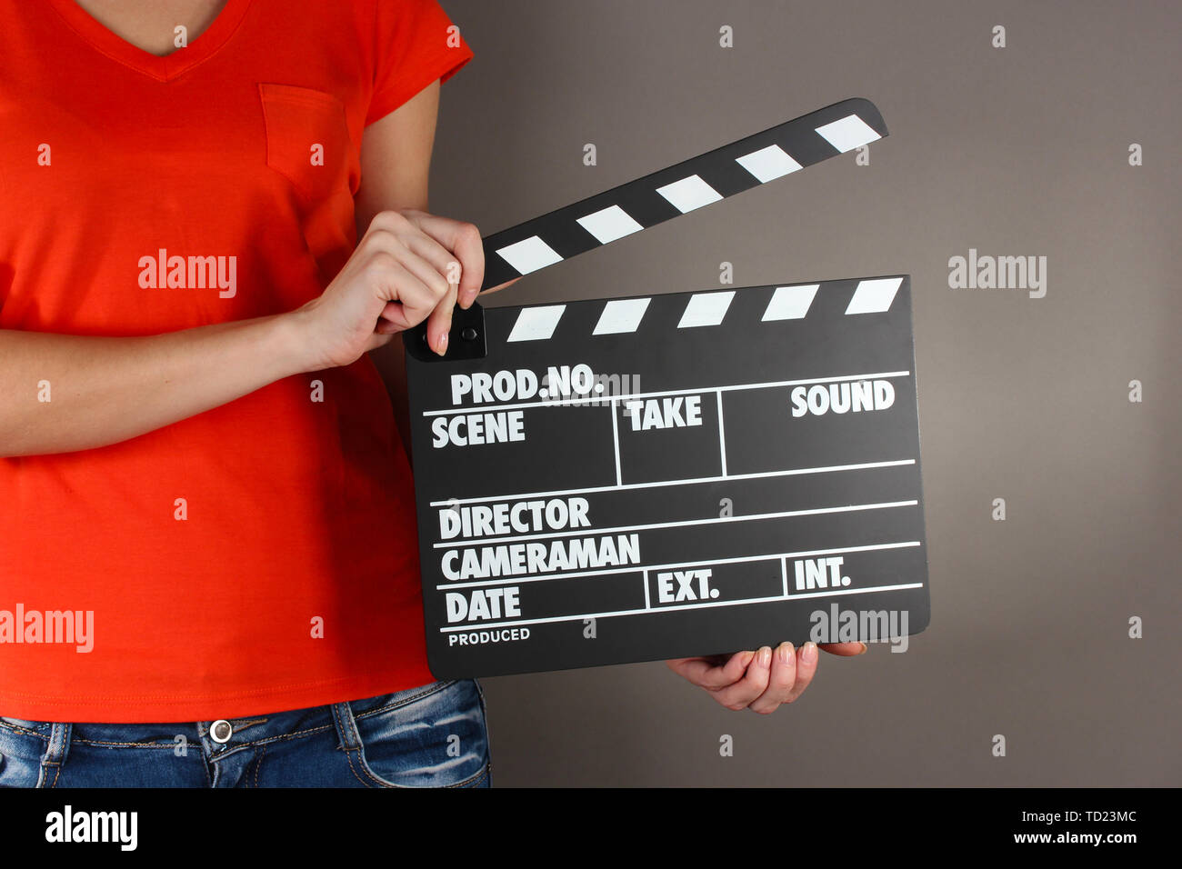 Movie production clapper board in hands on grey background Stock Photo ...
