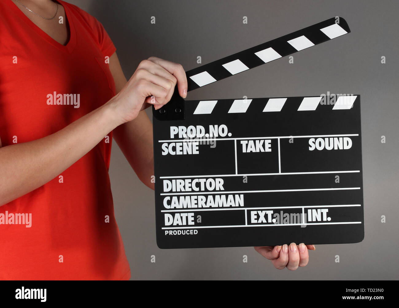 Movie production clapper board in hands on grey background Stock Photo ...