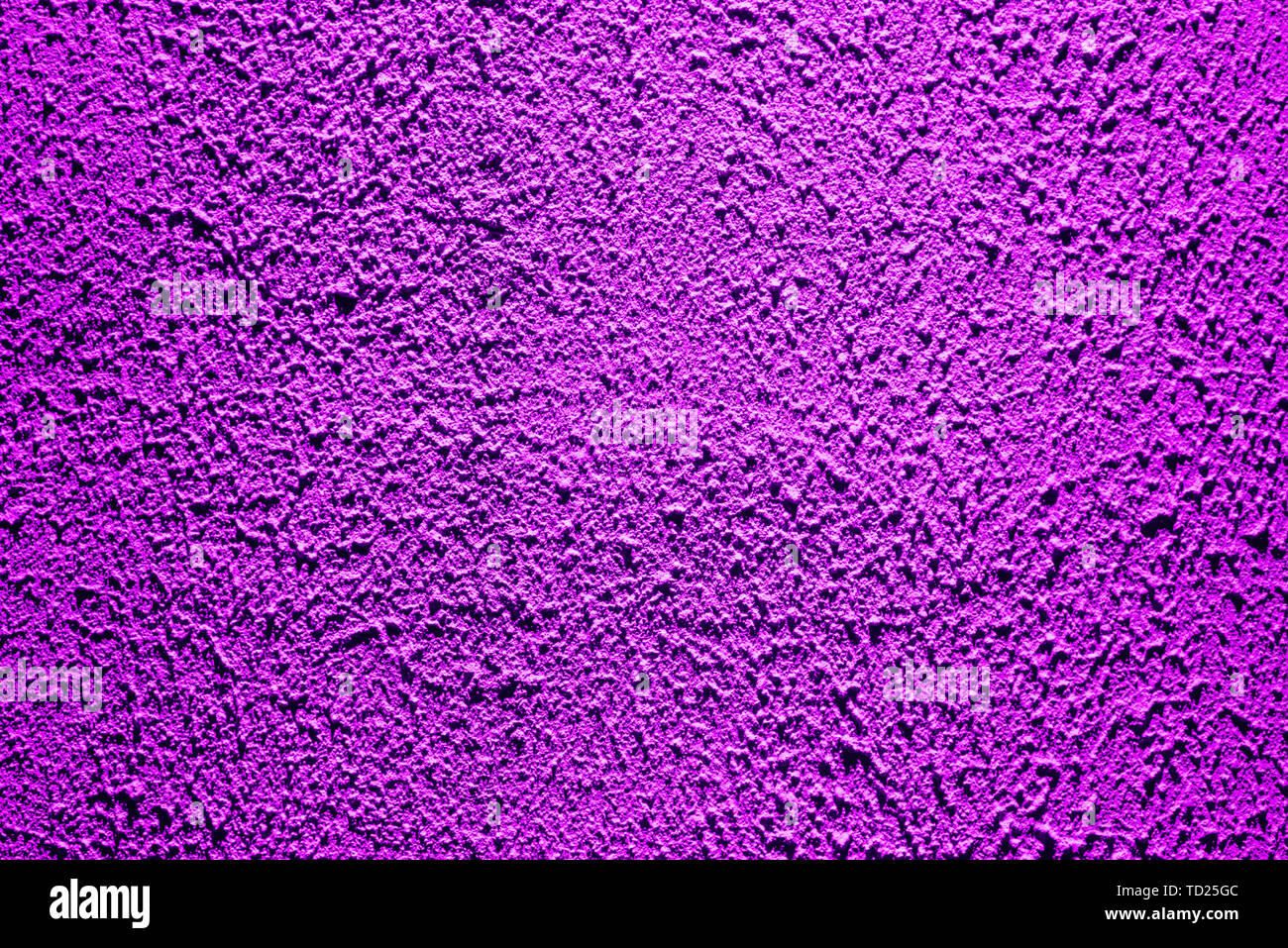 Brightly lit surface covered with bright purple plaster. Trend color ...