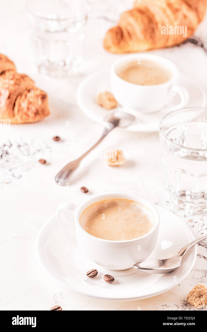 Traditional breakfast with fresh croissants on white background ...