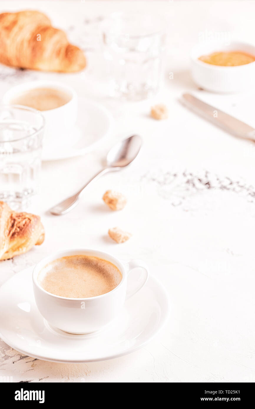 Traditional breakfast with fresh croissants on white background ...