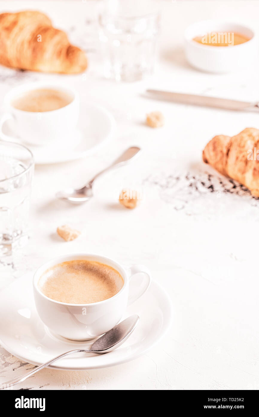 Traditional breakfast with fresh croissants on white background ...