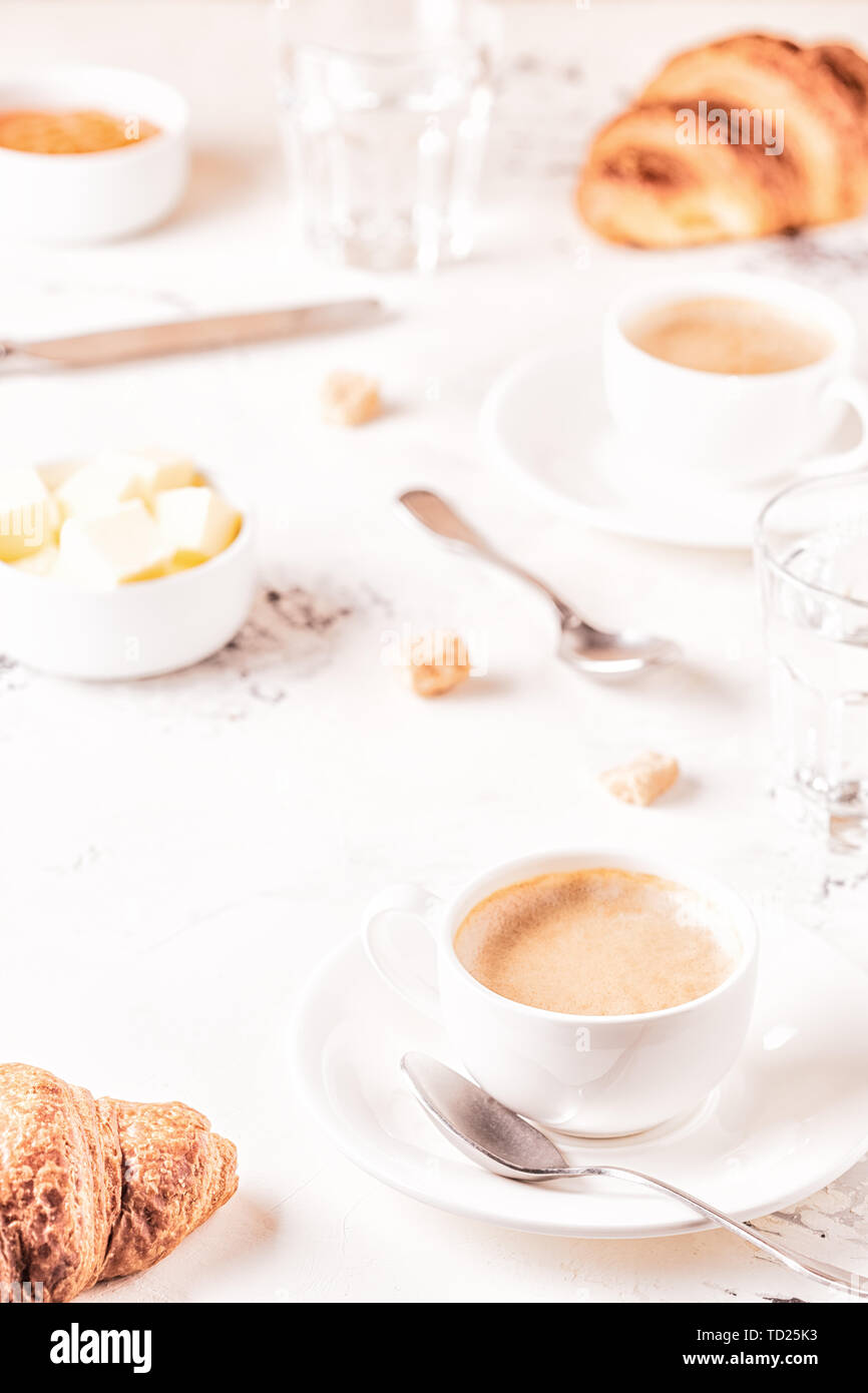Traditional breakfast with fresh croissants on white background ...