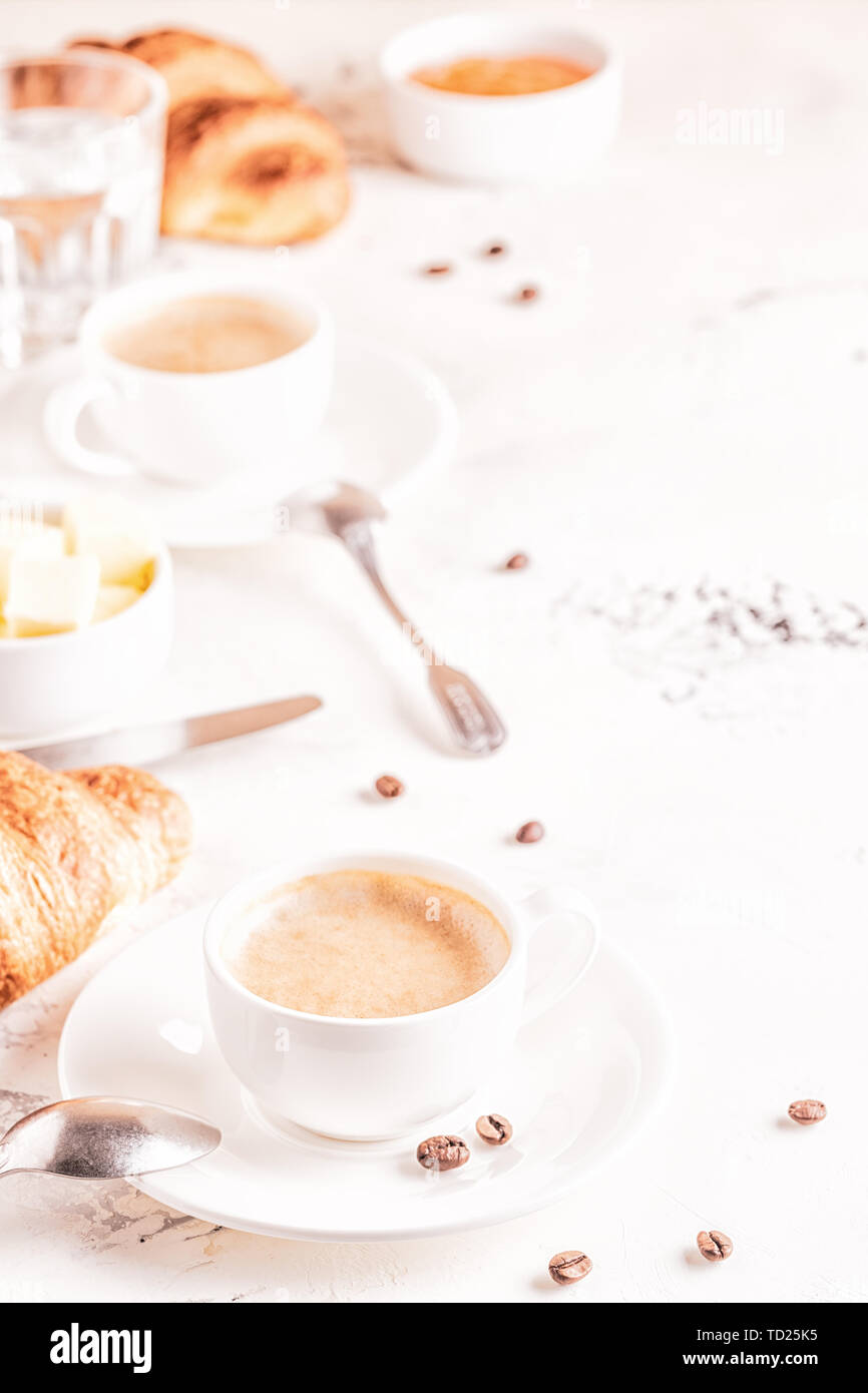 Traditional breakfast with fresh croissants on white background ...