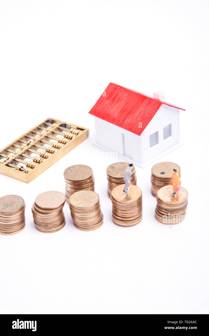 Coin house model and couple on white background Stock Photo - Alamy