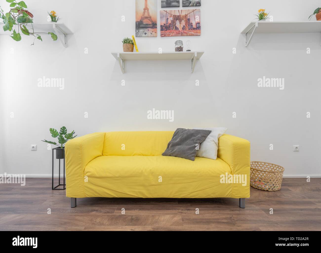 Interior of a modern house with a yellow couch Stock Photo - Alamy