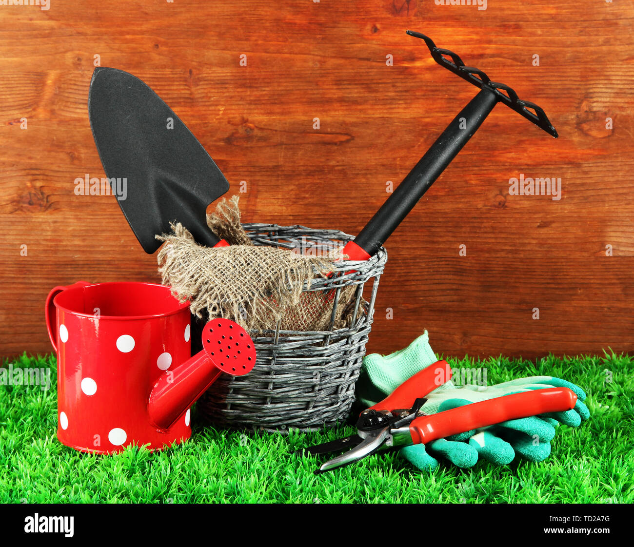 Garden tools on grass in yard Stock Photo - Alamy