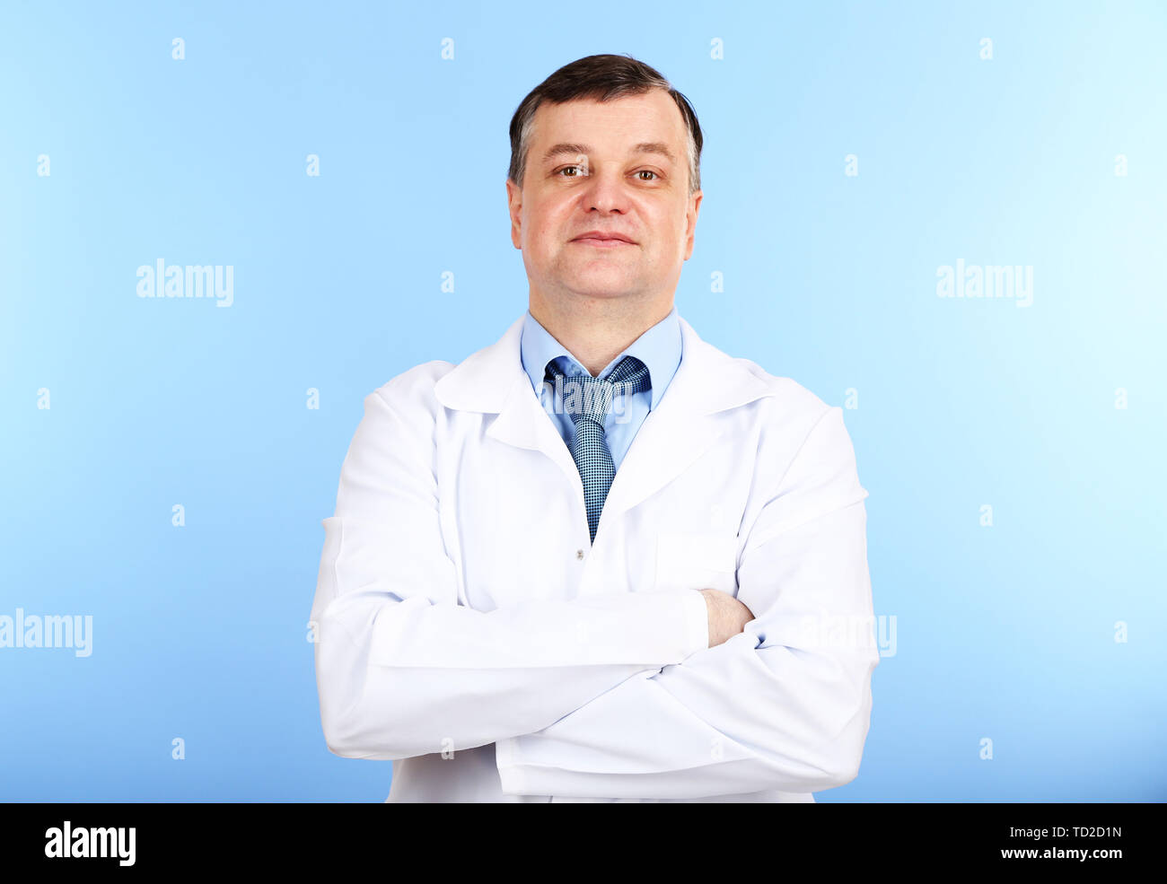 Medical doctor on blue background Stock Photo - Alamy