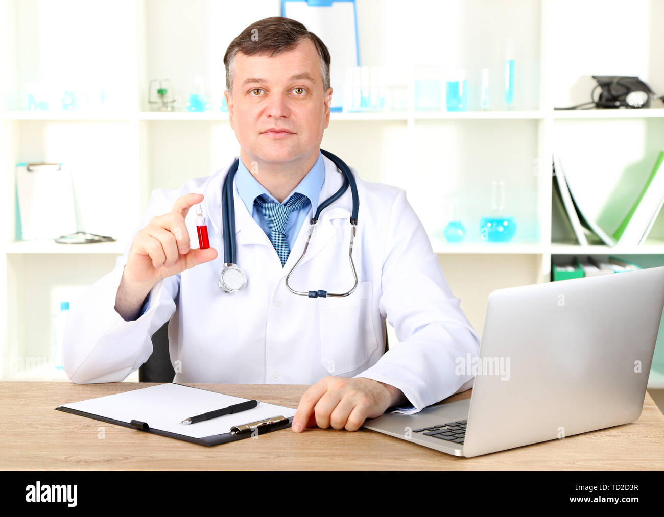 Medical doctor working at desk Stock Photo - Alamy