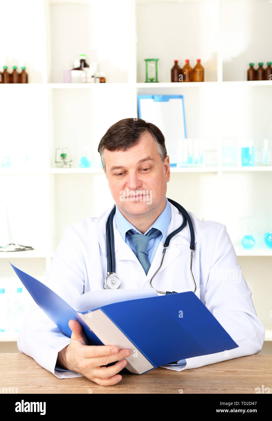 Medical doctor working at desk Stock Photo - Alamy