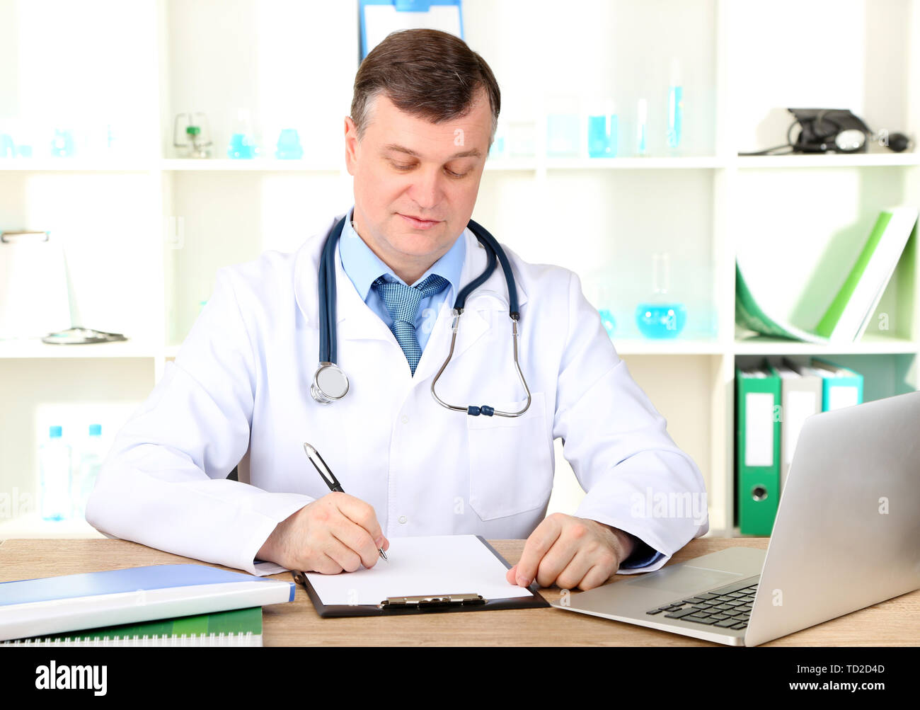 Medical doctor working at desk Stock Photo - Alamy