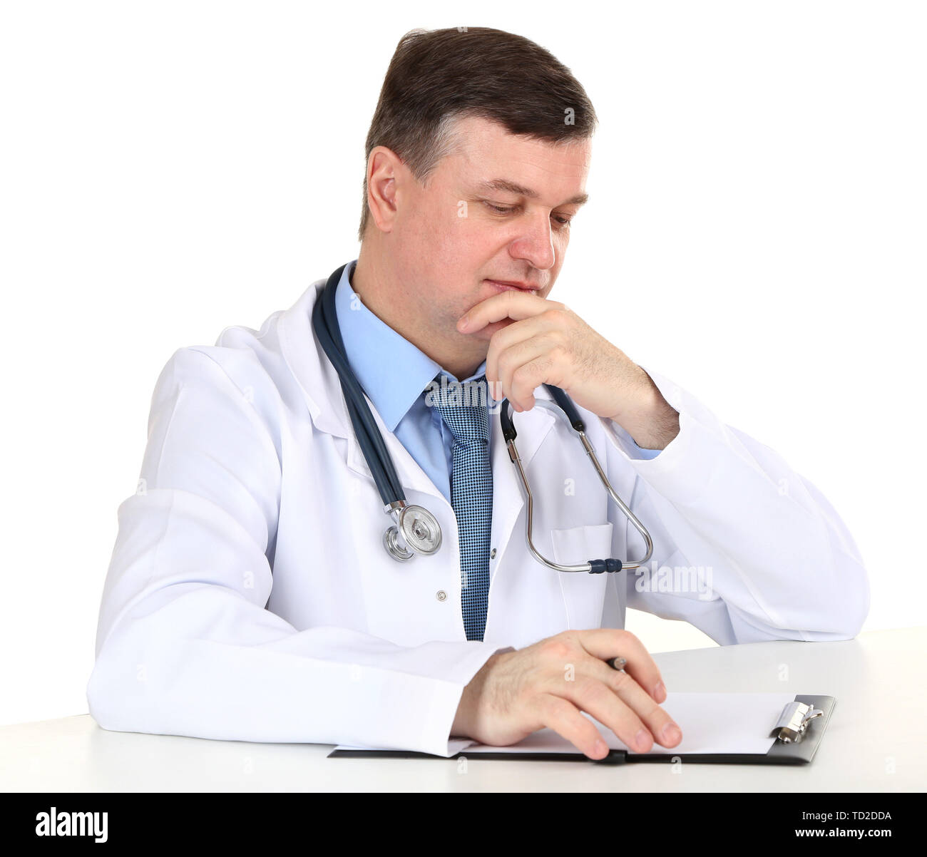 Medical doctor working at desk isolated on white Stock Photo - Alamy