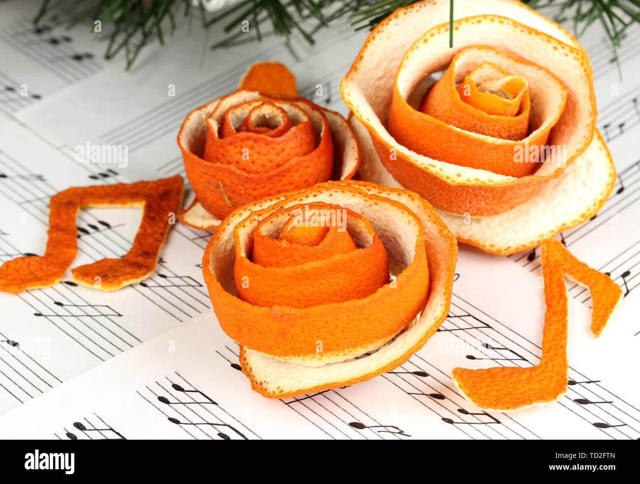 Decorative rose from dry orange peel on musical notes Stock Photo - Alamy