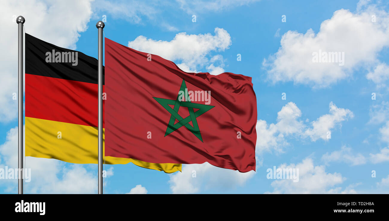Germany and Morocco flag waving in the wind against white cloudy blue ...
