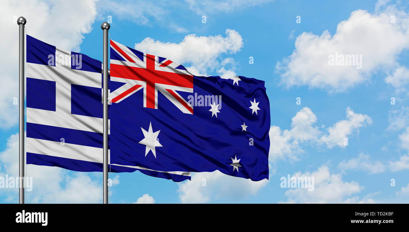 Greece and Australia flag waving in the wind against white cloudy blue ...