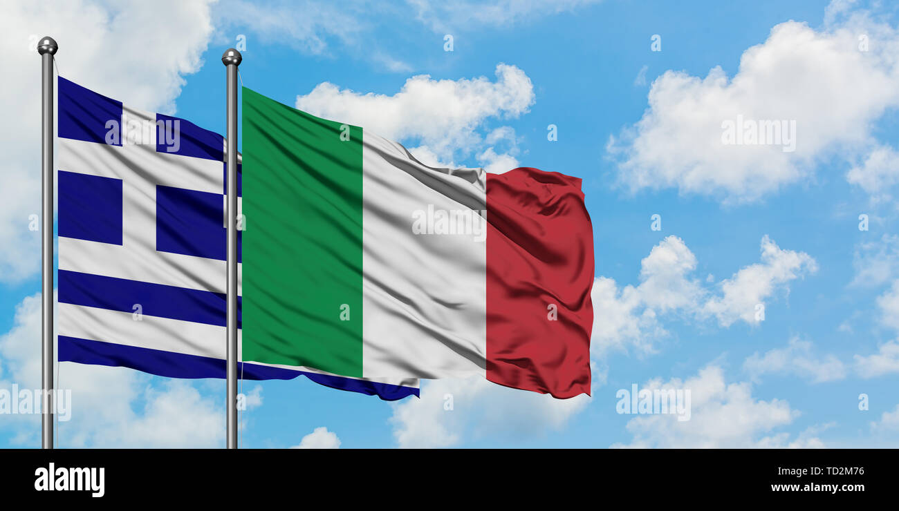 Greece and Italy flag waving in the wind against white cloudy blue sky ...