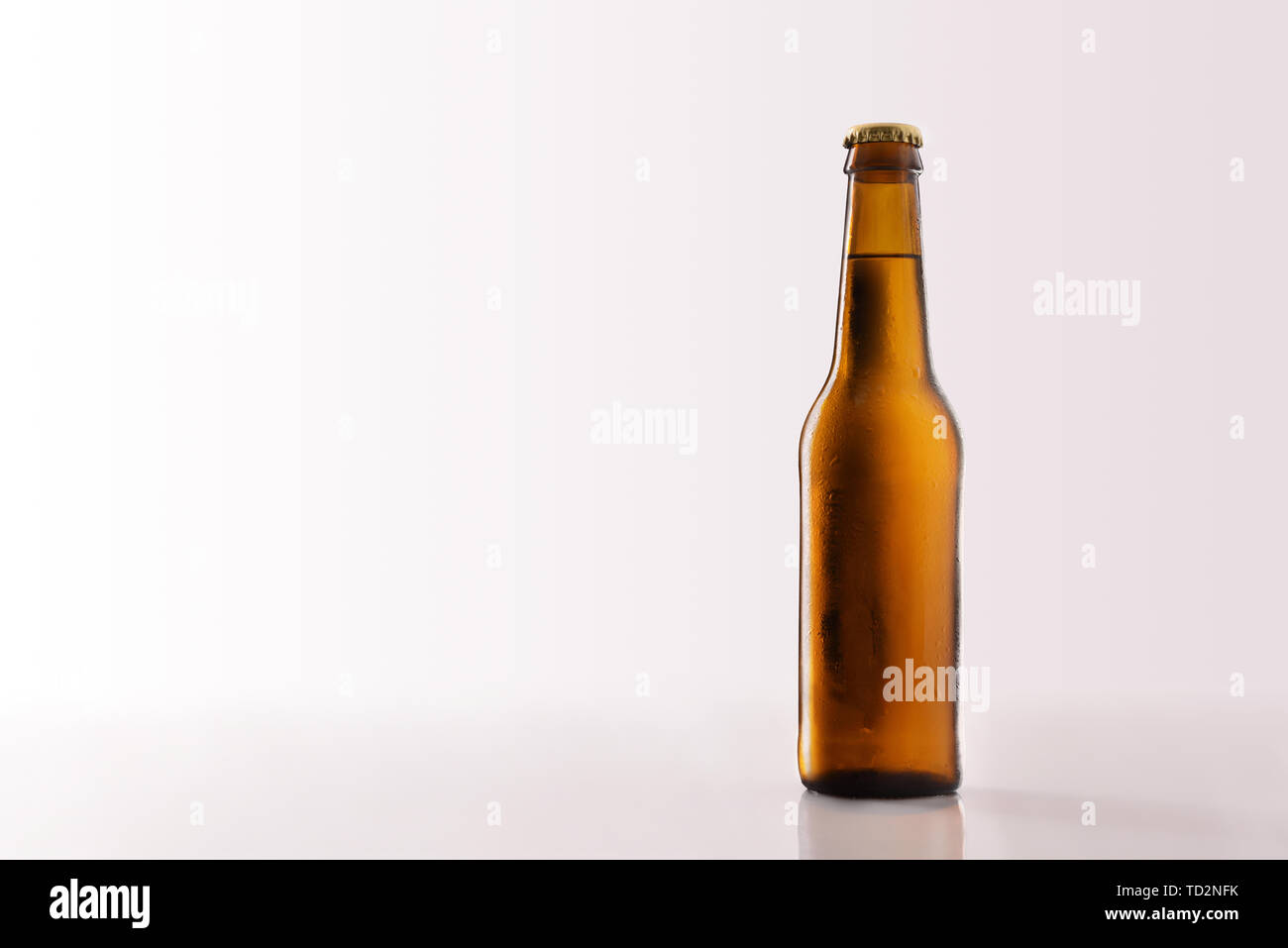 Beer bottle filled and closed on glass table and white background ...