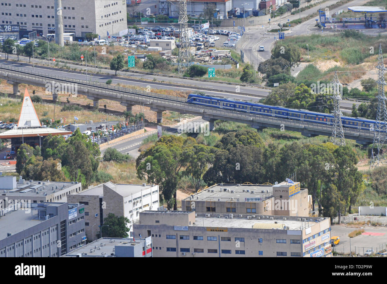 Passenger train passes through the industrial zone of Haifa Bay, Israel ...