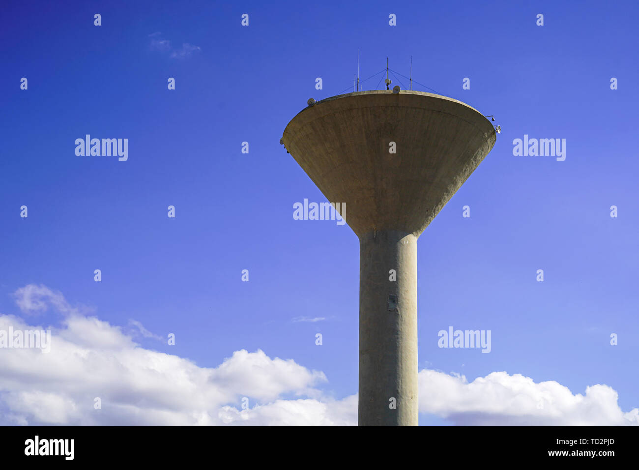 Concrete water tower on blue sky background Stock Photo - Alamy