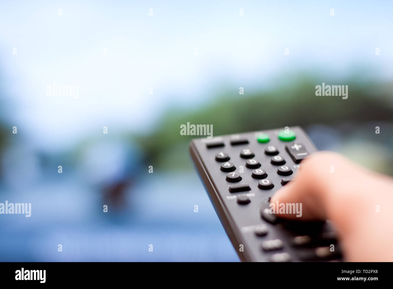 A hand changing the TV channel Stock Photo - Alamy