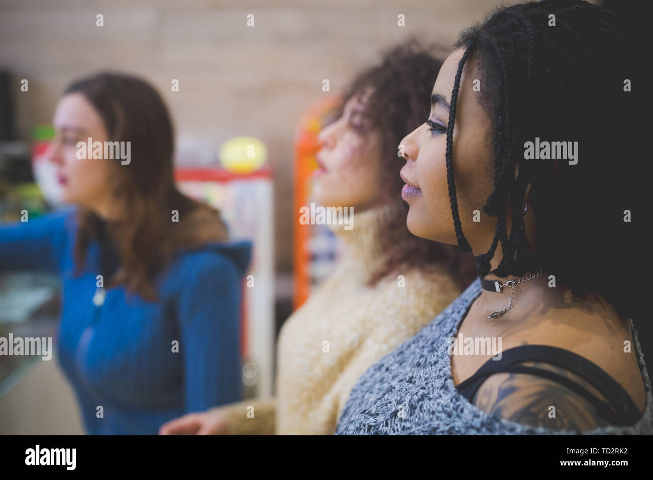 young multiracial women sitting together and having conversation ...