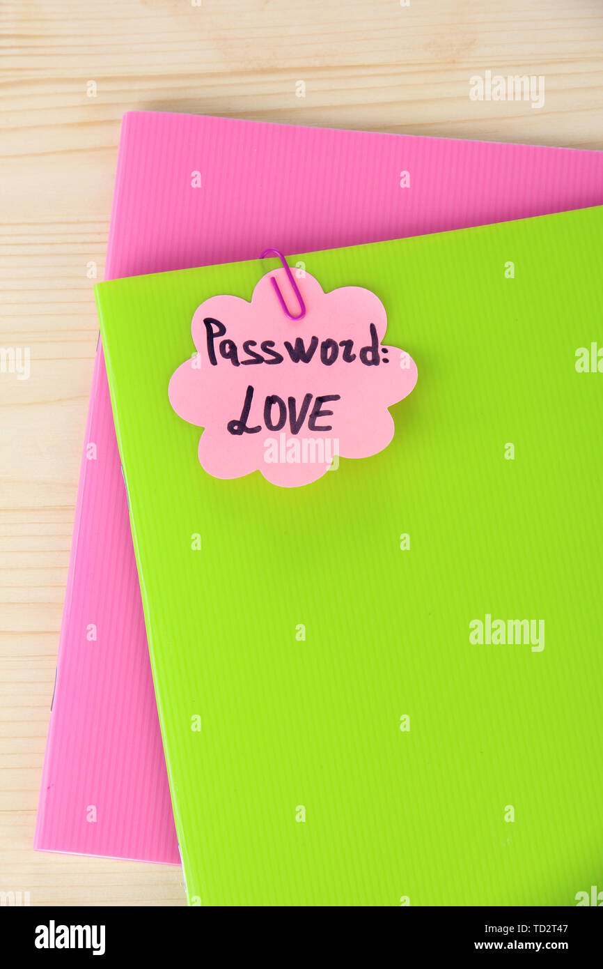 Sticker-reminder with most popular password, on notebook, on wooden ...