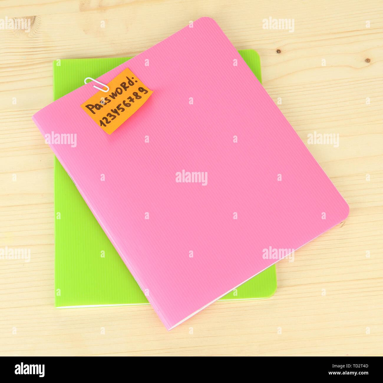 Sticker-reminder with most popular password, on notebook, on wooden ...