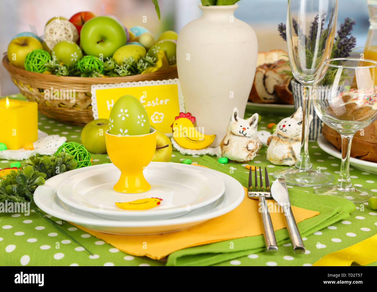 Serving Easter table on room background Stock Photo - Alamy