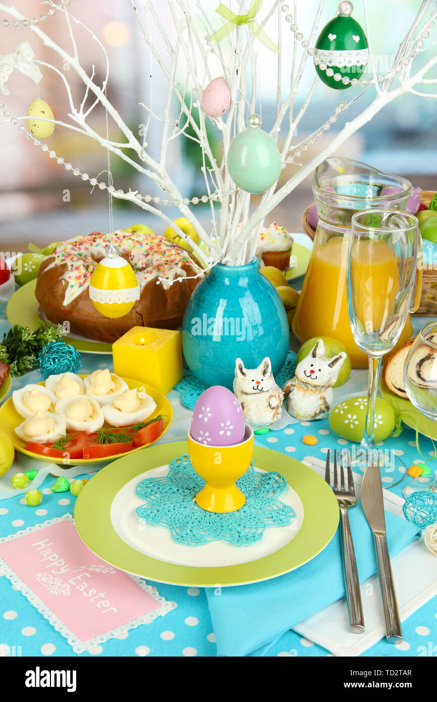 Serving Easter table with tasty dishes on room background Stock Photo ...