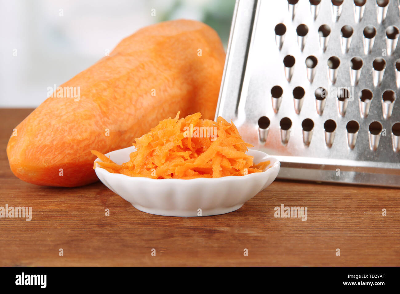 Metal grater and carrot, on bright background Stock Photo - Alamy