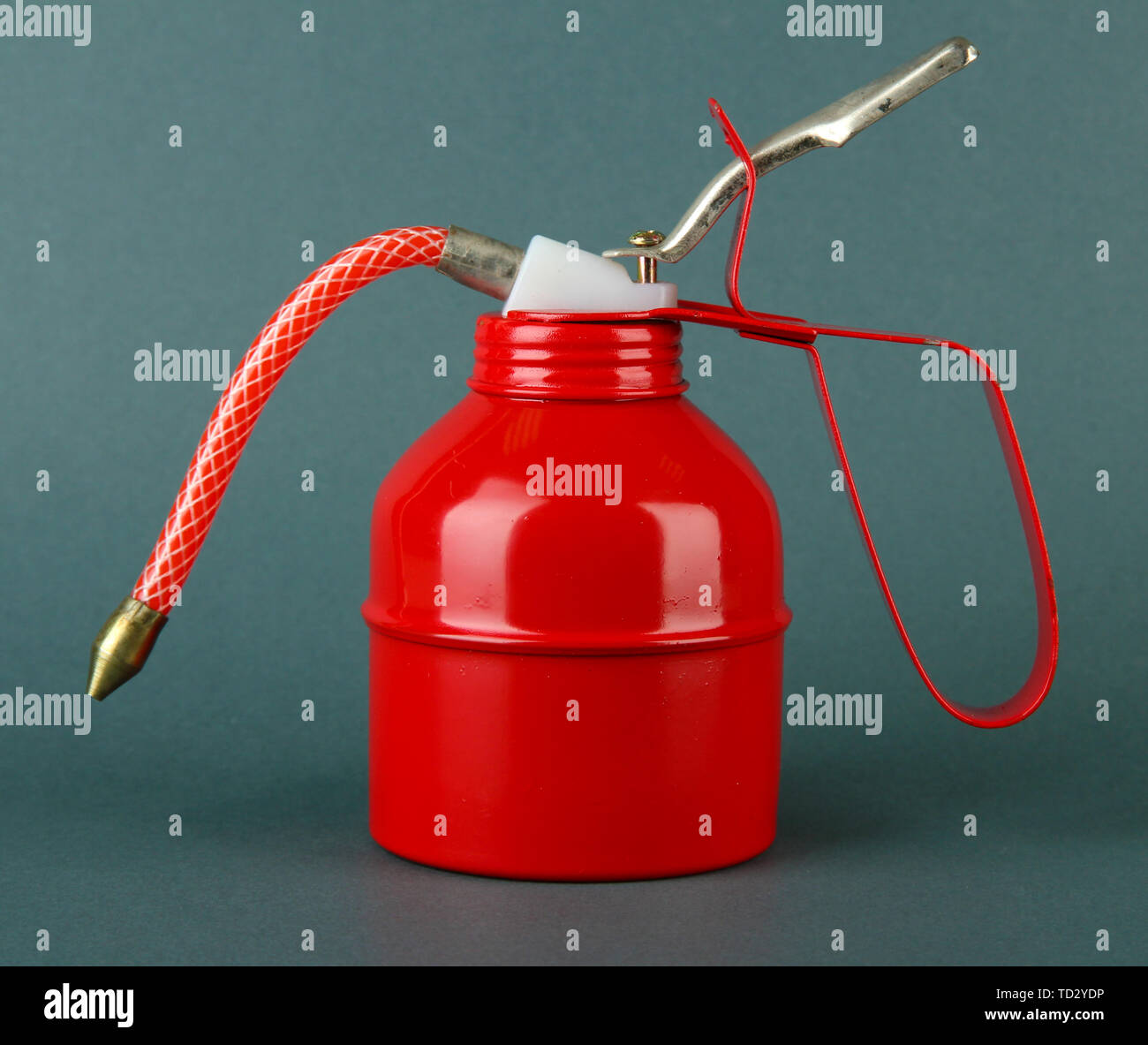 Red oil can, on color background Stock Photo - Alamy