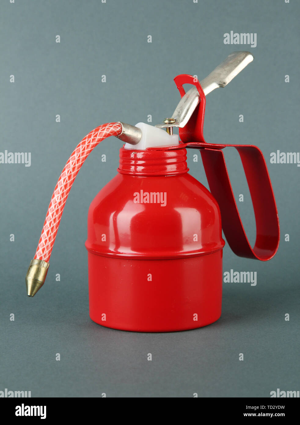 Red oil can, on color background Stock Photo - Alamy