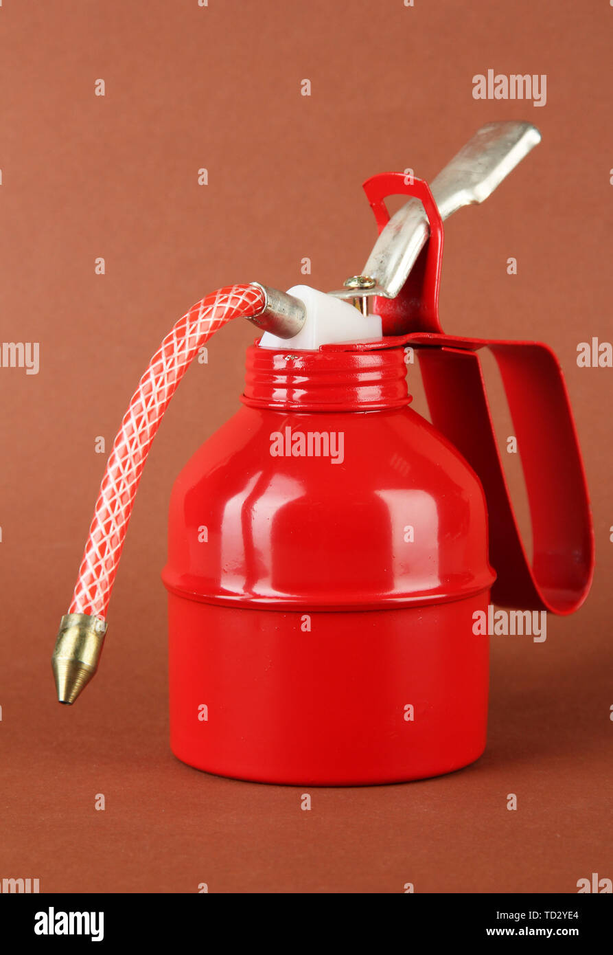 Red oil can, on color background Stock Photo - Alamy
