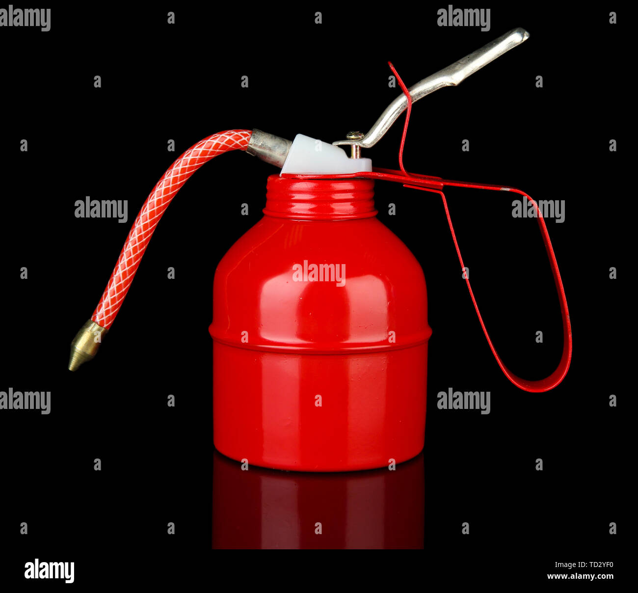 Red oil can, isolated on black Stock Photo - Alamy