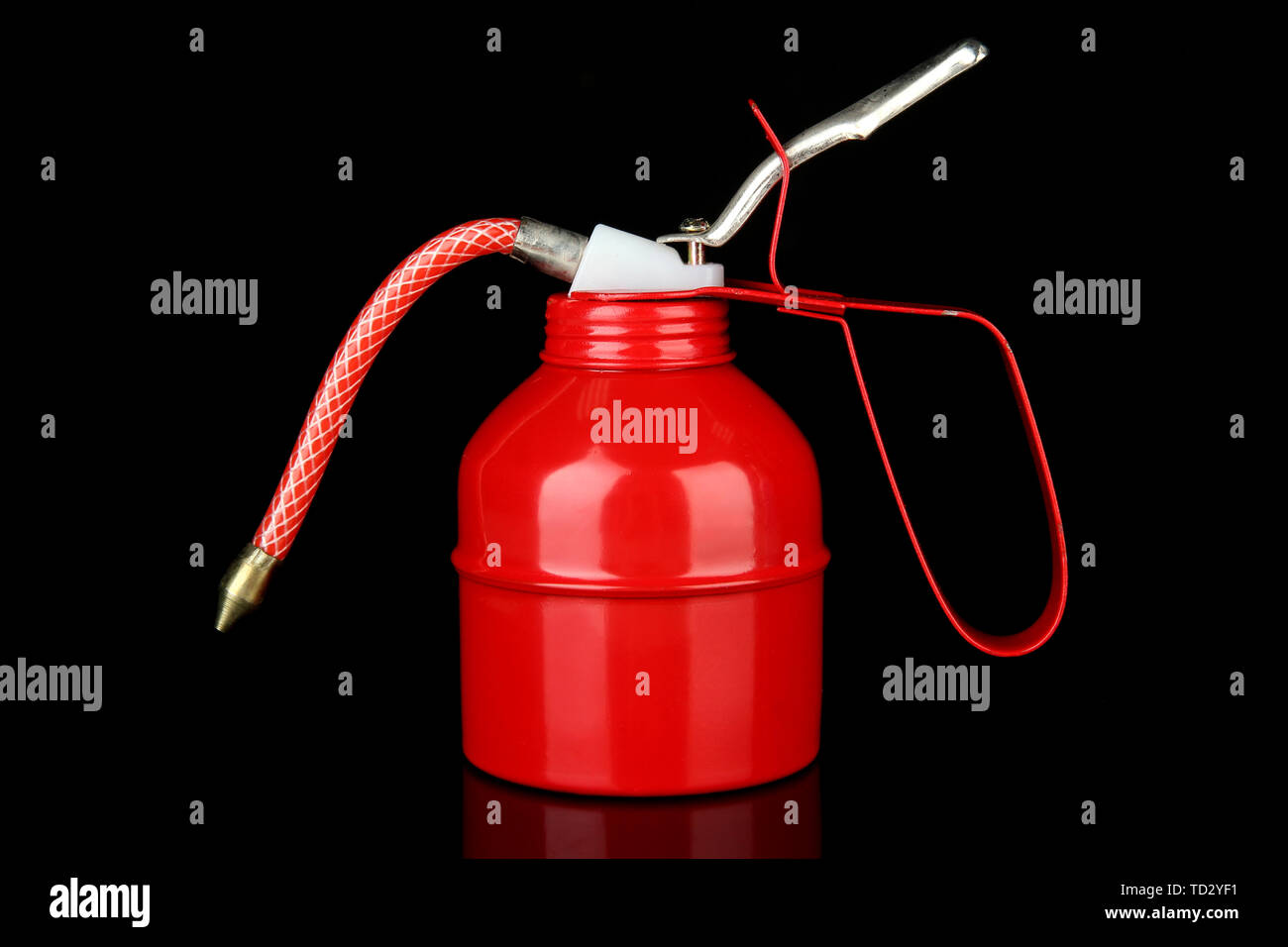 Red oil can, isolated on black Stock Photo - Alamy