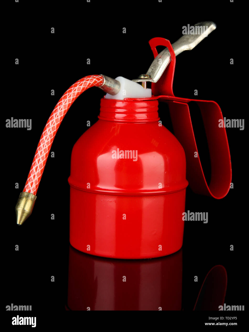 Red oil can, isolated on black Stock Photo - Alamy