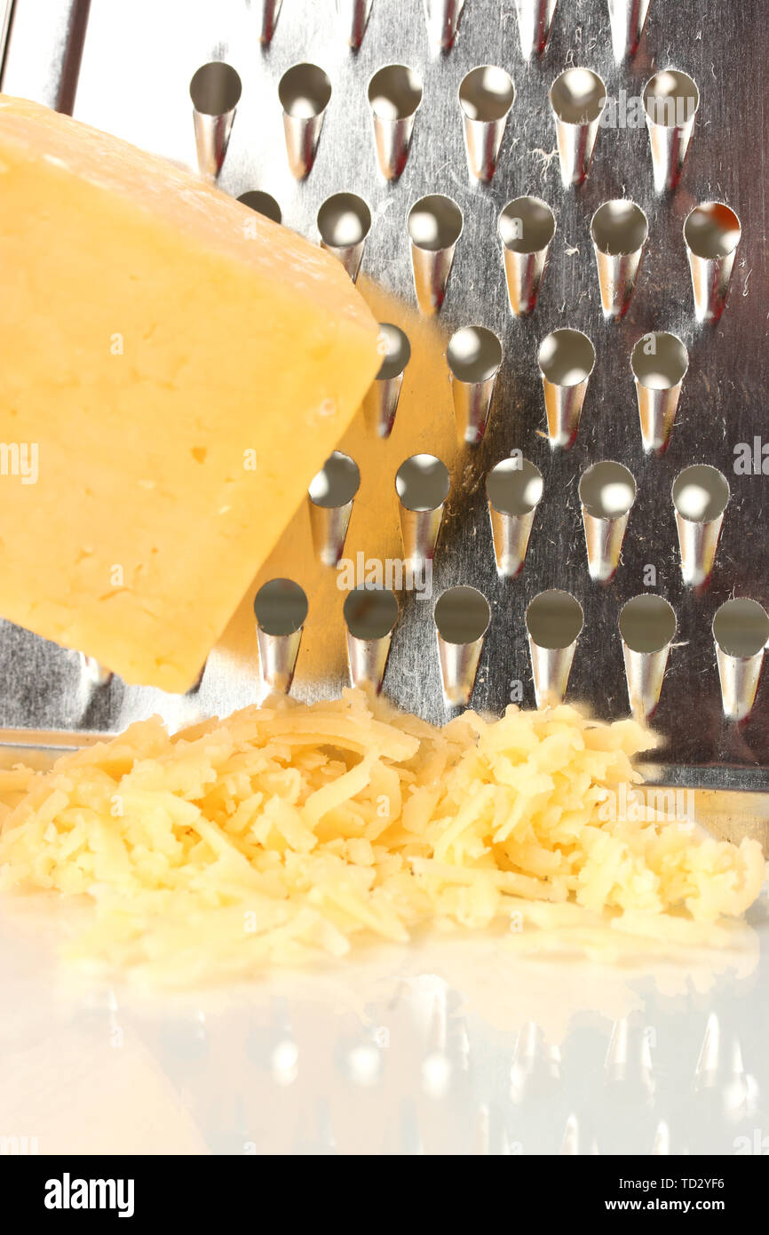 Metal grater and cheese, close up, isolated on white Stock Photo - Alamy