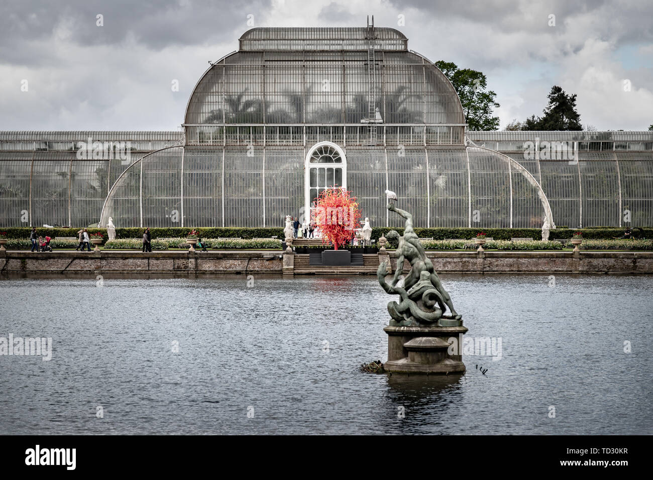 The view of the Palm House from across the water at Kew Gardens with ...