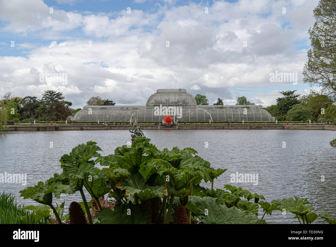 The view of the Palm House from across the water at Kew Gardens with ...