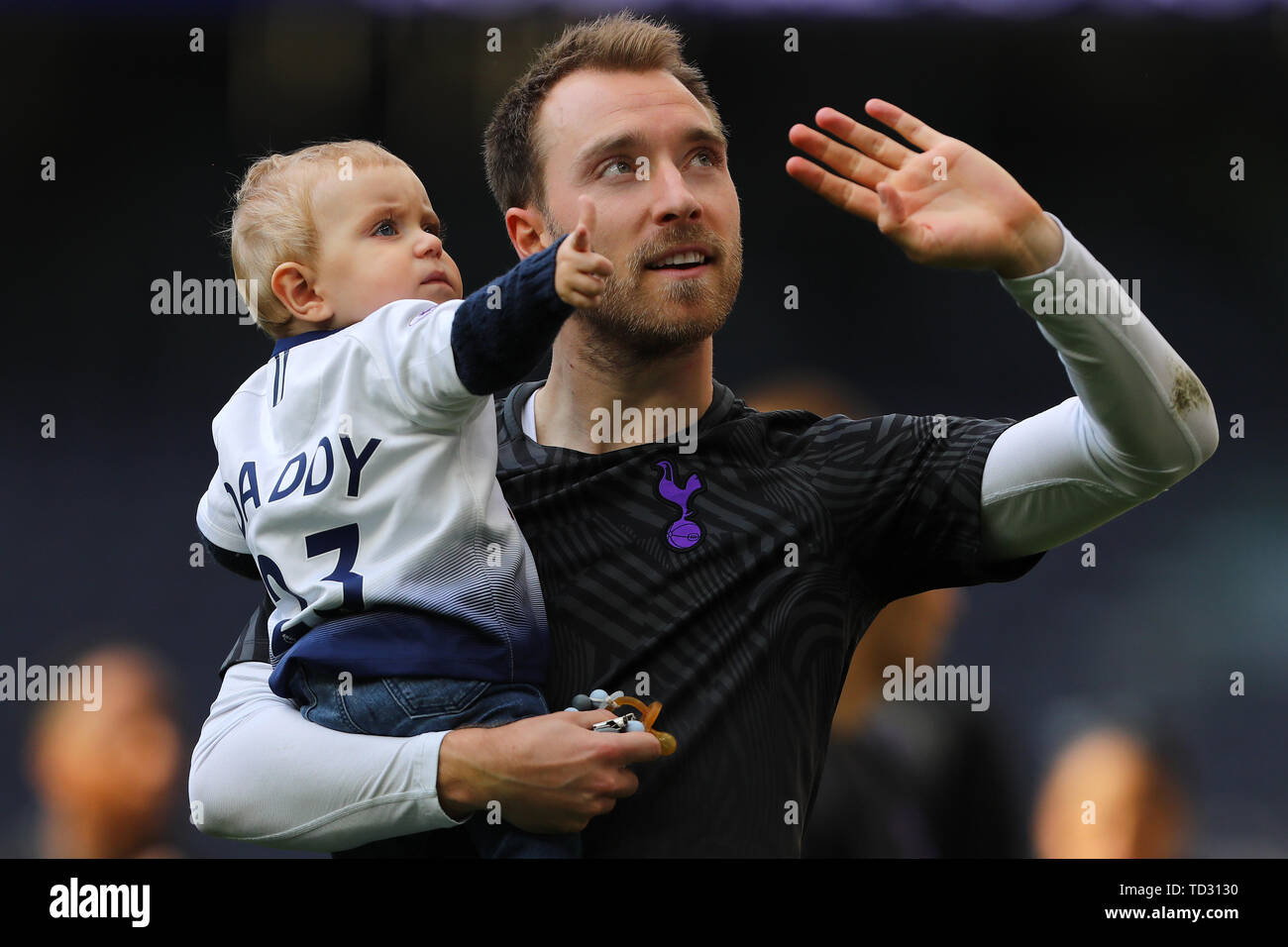 Christian Eriksen of Tottenham Hotspur and his child wave to the ...
